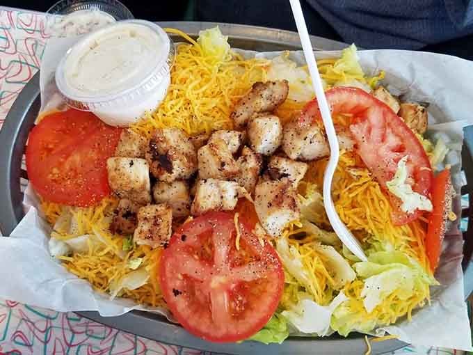 Fresh vegetables, grilled chicken, and enough cheese to make it interesting, this salad actually makes eating healthy look appealing.