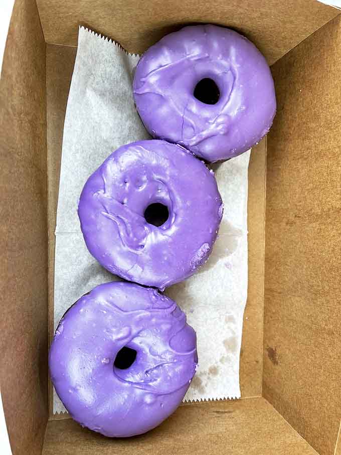 Three purple perfections nestled in their paper cradle &ndash; the color so vibrant you almost forget you're in Illinois and not some exotic island.