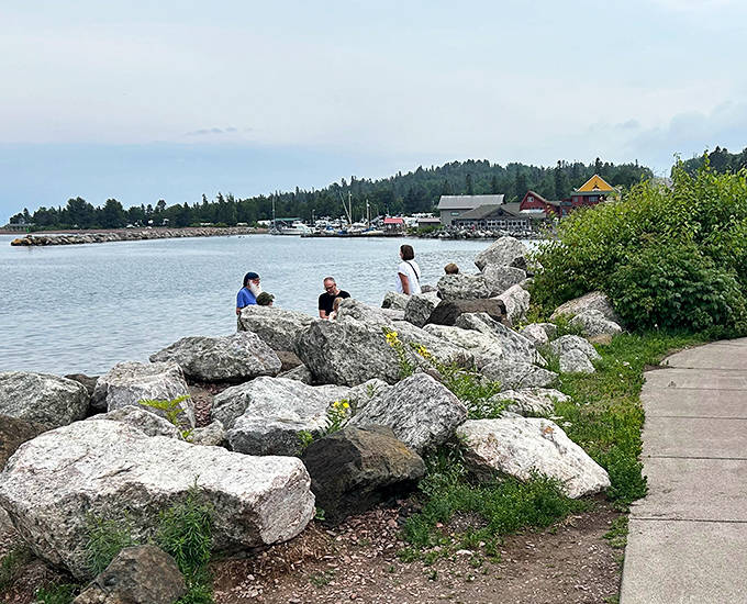 Harbor Park rocks become natural recliners for visitors soaking in Lake Superior views &ndash; nature's version of premium waterfront seating.