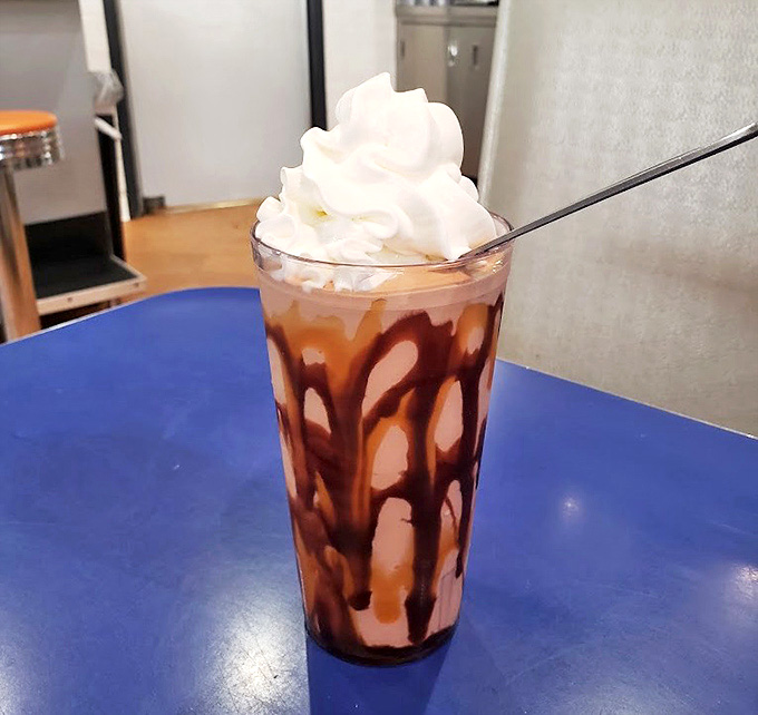 This isn't just a milkshake, it's a drinkable dessert with chocolate cascading down the sides like a sweet waterfall of morning indulgence.