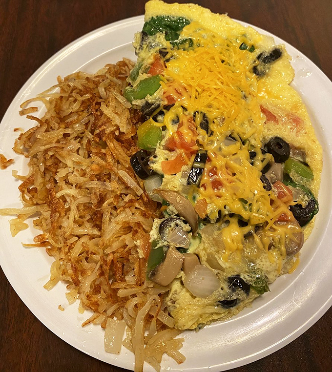A veggie omelet that proves eating your vegetables can be a pleasure, not a chore, especially alongside crispy hash browns.