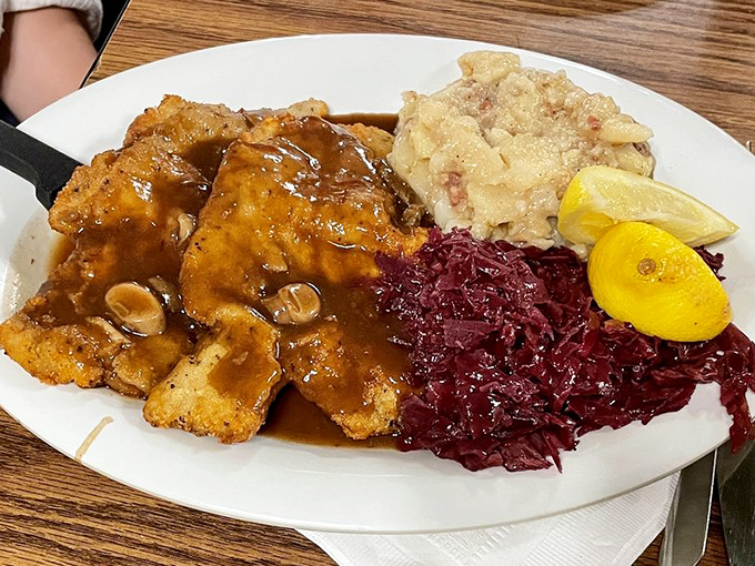 Wiener Schnitzel that's been pounded thin, breaded, and fried to golden perfection &ndash; served with red cabbage and potato salad for the full experience.