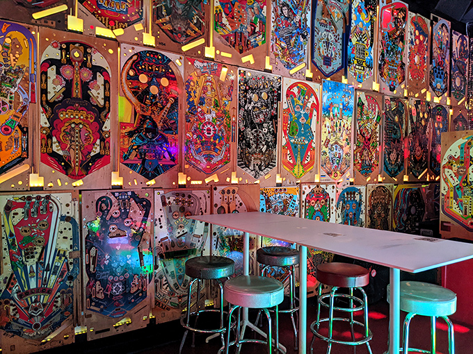 The bar's clever design incorporates actual pinball playfields as wall art &ndash; functional games transformed into conversation-starting d&eacute;cor that glows under blacklight.