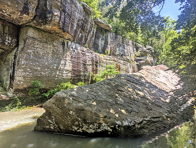 Imposing rock face tells geological stories spanning millions of years through its colorful sedimentary layers.
