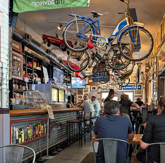 Vintage bicycles hang from the ceiling like mechanical art installations, creating a whimsical canopy that has first-time visitors pointing upward in delighted surprise.