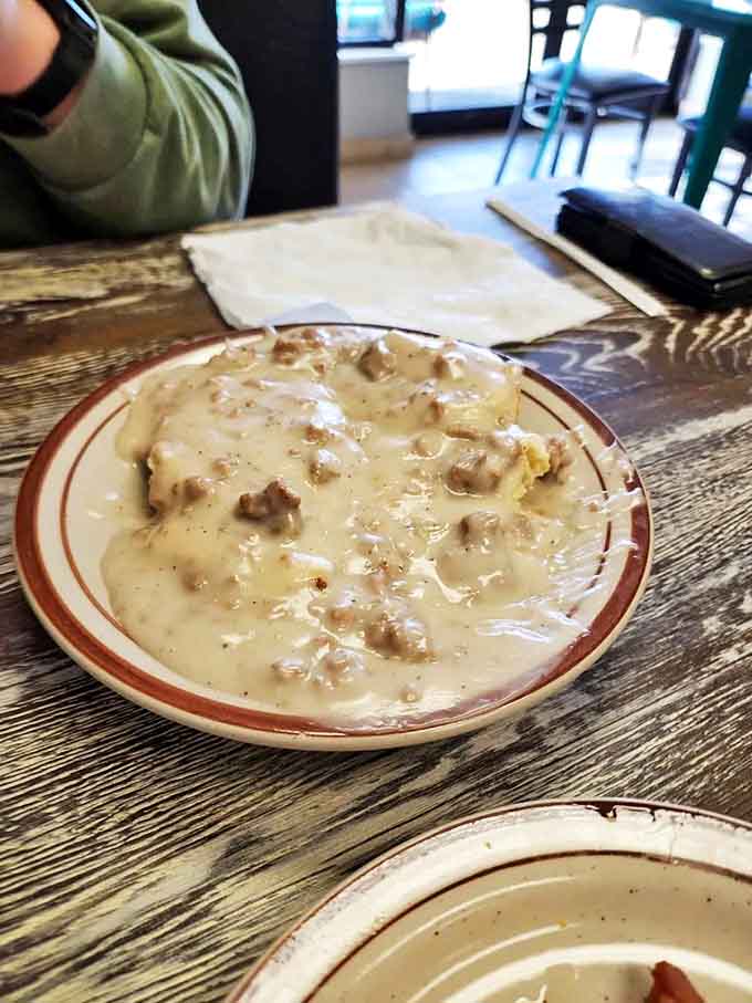 Biscuits swimming in sausage gravy &ndash; the breakfast equivalent of a warm hug from your favorite grandparent. Comfort food perfection!