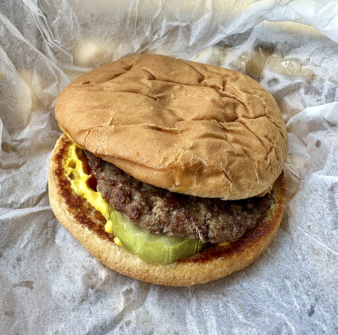 The classic American cheeseburger, no frills needed – hand-formed patty, melty American cheese, and fresh toppings on a soft bun that squishes just right.