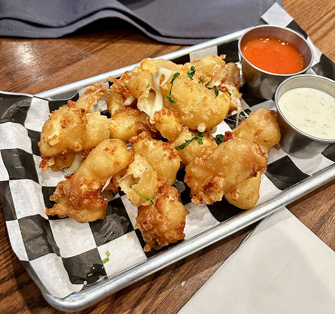 These aren't just any cheese curds &ndash; they're golden-battered nuggets of joy that stretch, squeak, and make you consider ordering a second batch.