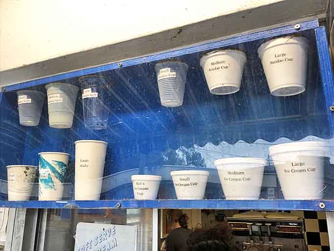 The wall of possibilities &ndash; these cup sizes aren't just measurements, they're life choices ranging from "reasonable treat" to "no regrets whatsoever."