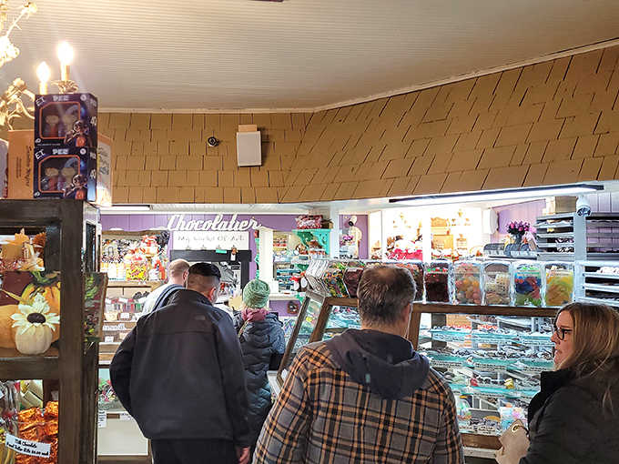 The universal language of anticipation &ndash; chocolate pilgrims patiently waiting their turn at the altar of sweetness, each contemplating their own sugar destiny.