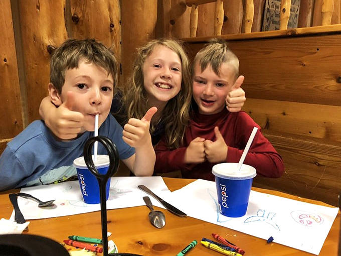 Young diners give the universal sign of approval. Nothing says "Minnesota family dining" like kids with straws and coloring sheets.
