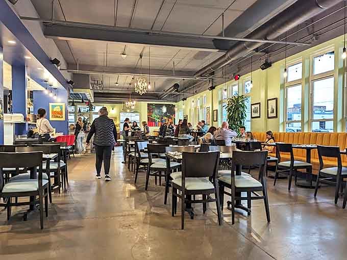 The dining room hums with conversation and clinking glasses, a symphony of satisfaction orchestrated by blue walls and golden lighting.