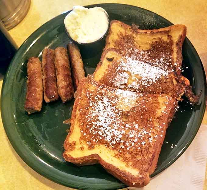 French toast dusted with powdered sugar alongside savory sausage links&mdash;the breakfast version of having your cake and eating it too.