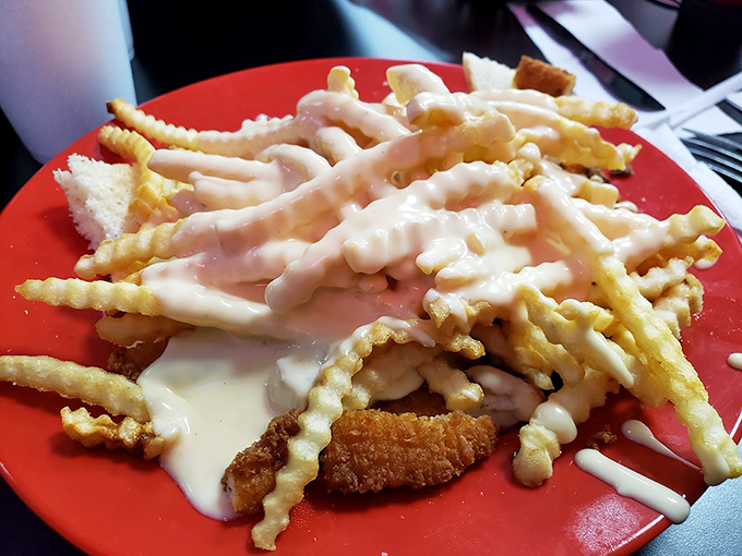 Crinkle-cut fries drowning in creamy white gravy &ndash; a beautiful mess that requires a fork, multiple napkins, and absolutely zero regrets.