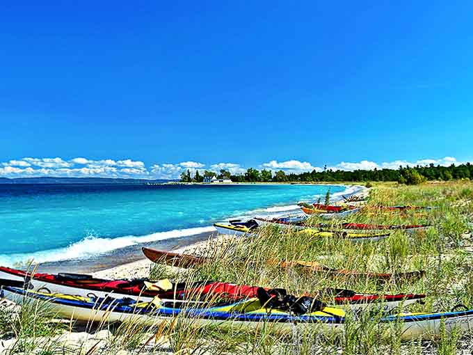 Colorful kayaks wait patiently for adventure, like a fleet of water-going candy ready to deliver you to hidden coves and secret beaches.