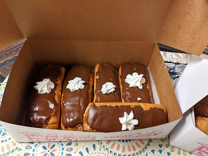 Long Johns: Chocolate-topped torpedoes of pleasure lined up like delicious dominoes, each one offering more surface area for that perfect frosting-to-dough ratio.