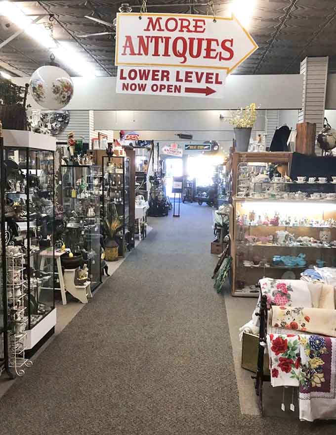 The "More Antiques" sign points downward like an invitation to Alice's rabbit hole &ndash; another level of treasures awaits the dedicated explorer.