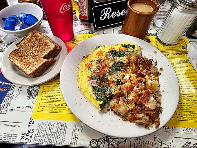 An omelet that's seen things, paired with hash browns that have achieved the perfect crisp-to-tender ratio that science still can't explain.