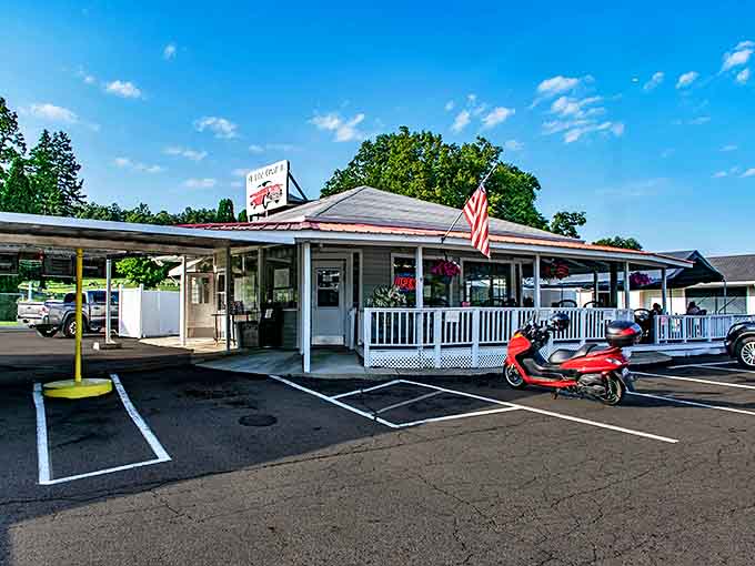 The charming exterior beckons hungry travelers with its classic drive-in design, red trim, and the promise of comfort food that transcends time.