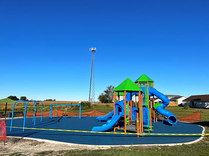 The new playground gleams with primary colors against the prairie sky, promising adventures scaled perfectly for the smallest citizens.