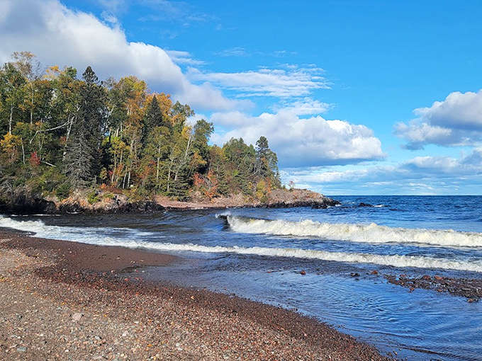 Lake Superior's shoreline offers a rugged beauty where forest meets water – no sandy beaches here, just dramatic rocks perfect for contemplative sitting.