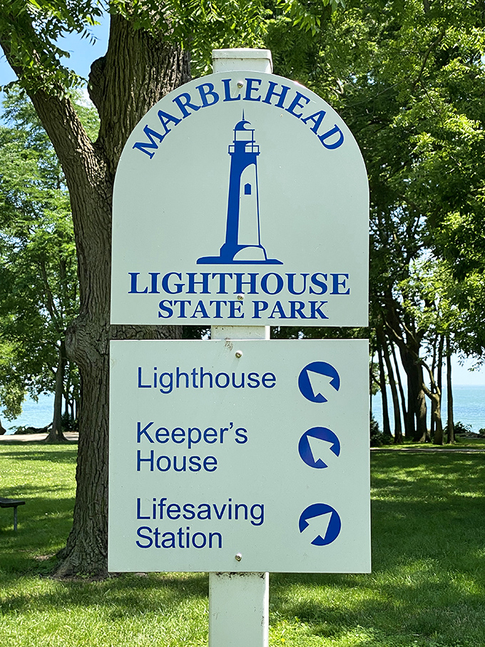 The official park sign welcomes visitors, promising three historic treasures to explore – the lighthouse, keeper's house, and lifesaving station await your discovery.