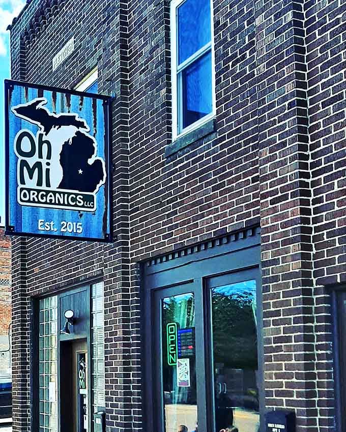 Signage: The blue Michigan-shaped sign serves as a beacon for chocolate pilgrims, promising sweet treasures inside this unassuming brick building.