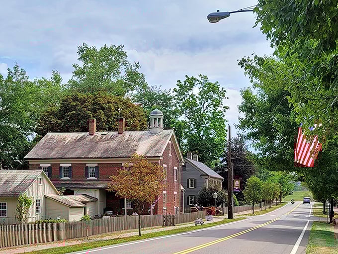 American flags flutter against brick facades on Zoar's main street, where history lives in every doorway.