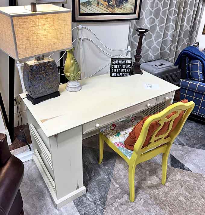 That sunny yellow chair paired with a pristine desk creates a workspace that would make even expense reports feel cheerful.