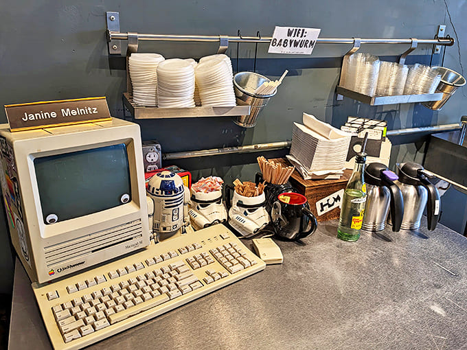 An original Macintosh computer sits ready for action, surrounded by Star Wars figurines and other 80s treasures that transport visitors to simpler times.