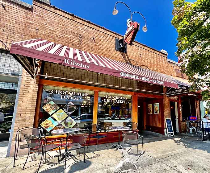 Kilwins' charming brick storefront with burgundy awning fits perfectly into Harbor Springs' upscale yet relaxed atmosphere. The outdoor seating creates a perfect spot for people-watching with your cone.