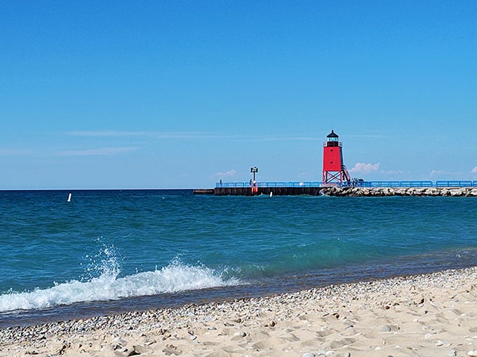 Michigan Beach Park's iconic red lighthouse stands guard over Charlevoix's picturesque shoreline, creating postcard-worthy views.