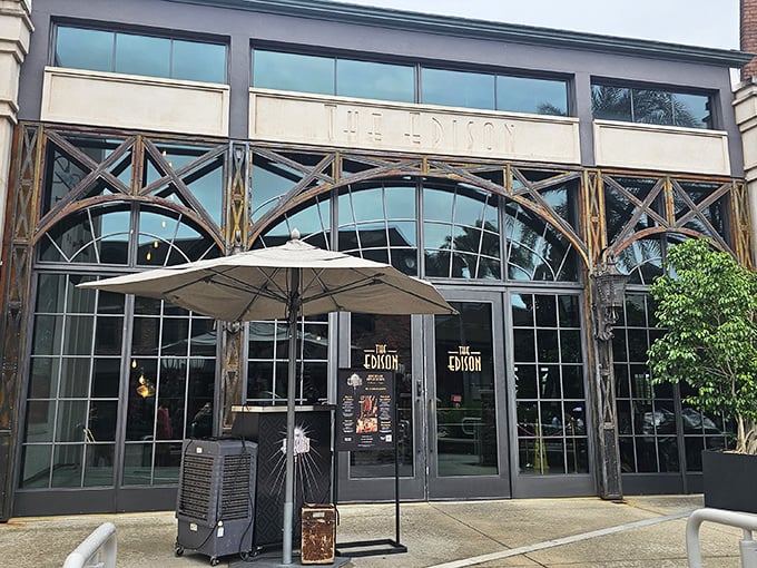 The Edison's grand entrance features elegant industrial architecture with art deco influences. The arched windows hint at the 1920s power plant theme inside.