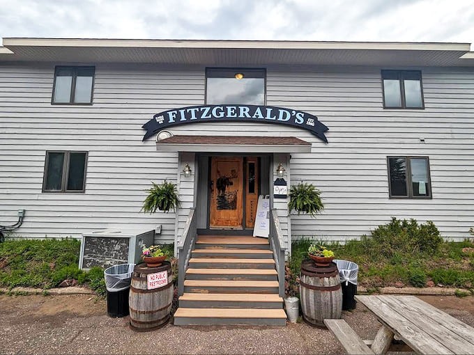 Fitzgerald's welcomes hungry travelers with rustic charm and the promise of smoky delights, those wooden barrels hinting at the culinary journey ahead.