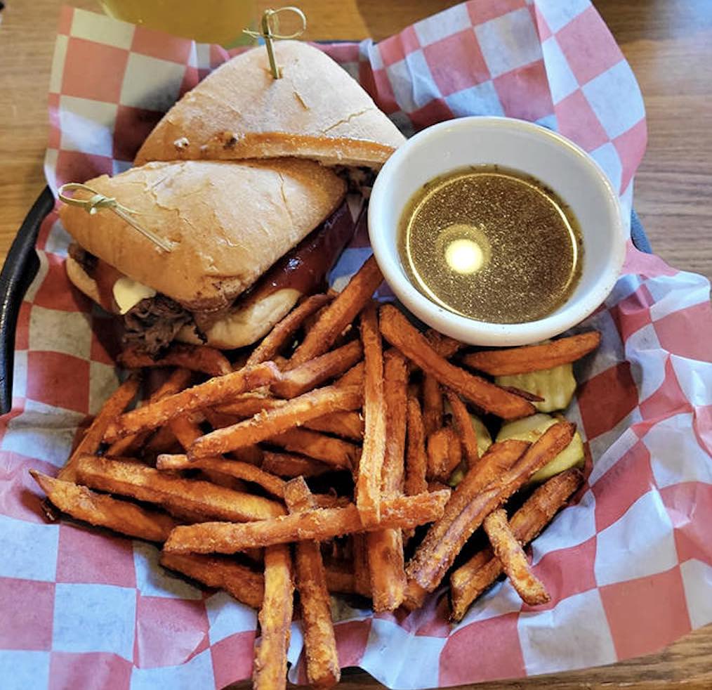 This isn't just a sandwich, it's an event. House-smoked prime rib nestled in ciabatta with that cup of au jus waiting for its moment.