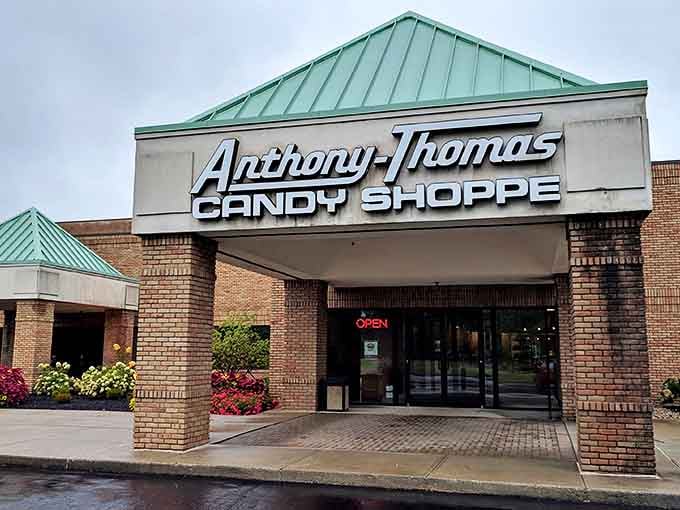 The welcoming facade of Anthony-Thomas Candy Shoppe beckons chocolate lovers with its distinctive green roof and brick exterior &ndash; a sweet beacon in Columbus.