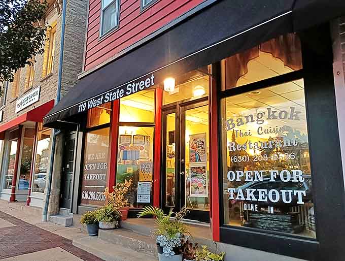 The welcoming red-trimmed exterior of Bangkok Restaurant stands as a culinary beacon on Geneva's charming West State Street, promising authentic Thai flavors within.