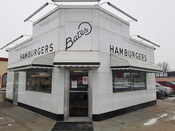 The iconic white exterior of Bates Burgers stands like a time capsule on Five Mile Road, beckoning burger lovers since the Eisenhower era.