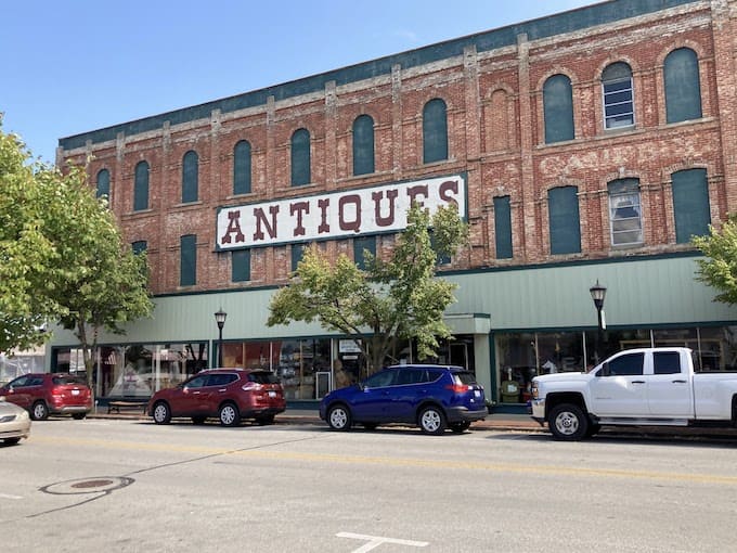That "ANTIQUES" sign isn't kidding around, this historic brick building houses enough treasures to keep you browsing until your phone battery dies twice.