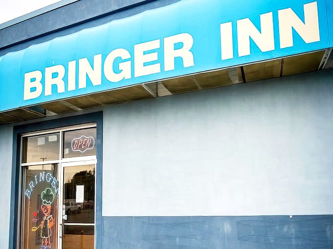 The iconic blue exterior of Bringer Inn stands out in Brimley like a beacon for hungry travelers seeking potato perfection.