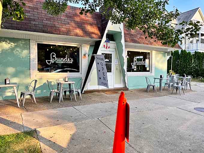 A mint-green A-frame building with distinctive peaked roof beckons pastry lovers like a lighthouse for carb enthusiasts.