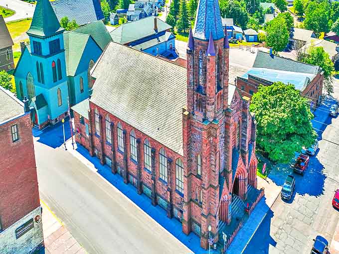 Calumet's striking red sandstone churches reach skyward, their twin spires standing as copper-country sentinels against the Michigan sky.
