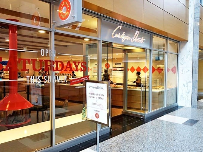The welcoming storefront of Cardigan Donuts beckons passersby with its warm glow and promise of sweet delights in downtown Minneapolis.