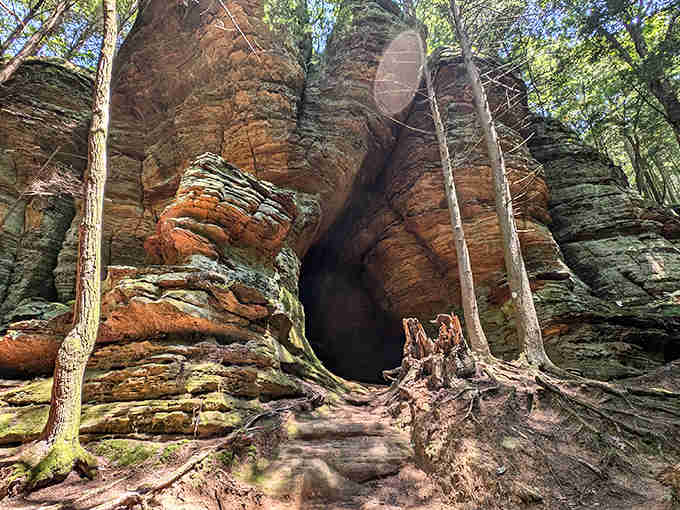 Nature's grand entrance: Chapel Cave's imposing sandstone archway stands like a portal between worlds, inviting explorers into its ancient embrace.