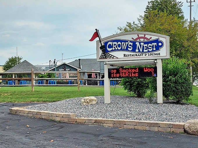 The unassuming exterior of Crow's Nest belies the culinary treasures within, with its charming sign promising "Smoked Moo" and other delights.