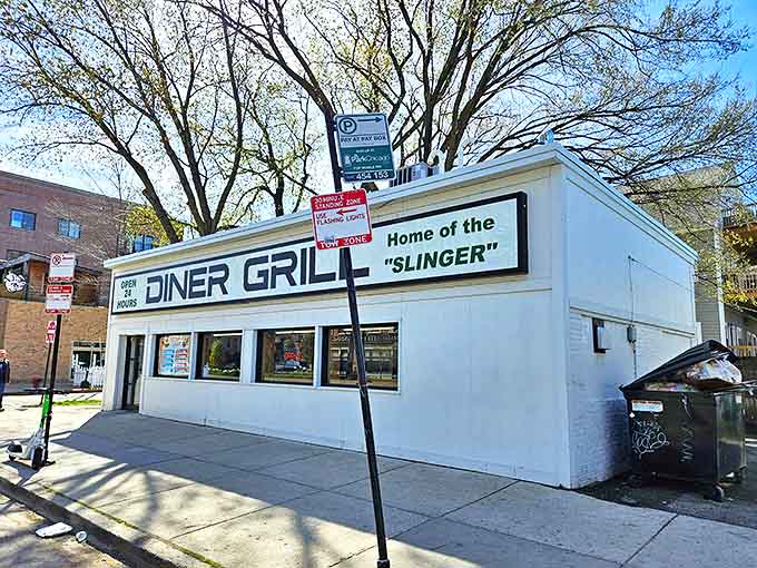 The unassuming white exterior of Diner Grill proudly announces itself as "Home of the Slinger" – Chicago's legendary breakfast challenge.
