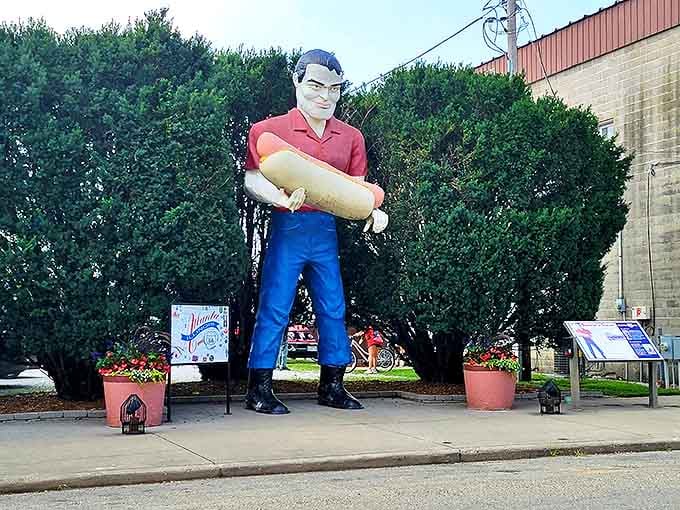 The Bunyon Giant stands tall in Atlanta, Illinois, proudly clutching his oversized hot dog like a trophy from a meat-lovers convention.