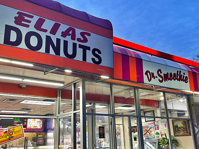 The iconic red and white Elias Donuts sign beckons hungry Detroiters like a neon promise of deliciousness waiting just beyond those glass doors.