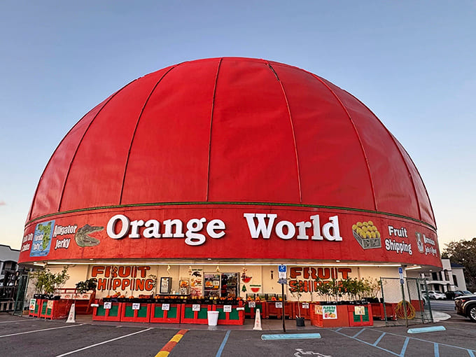 The unmistakable crimson dome of Orange World stands like a citrus beacon along Highway 192, promising fruity treasures within.