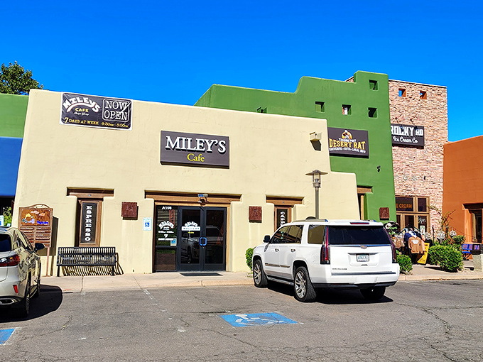 Miley's Café welcomes hungry visitors with its charming pueblo-style exterior, a cream-colored beacon of breakfast hope amid Sedona's colorful landscape.
